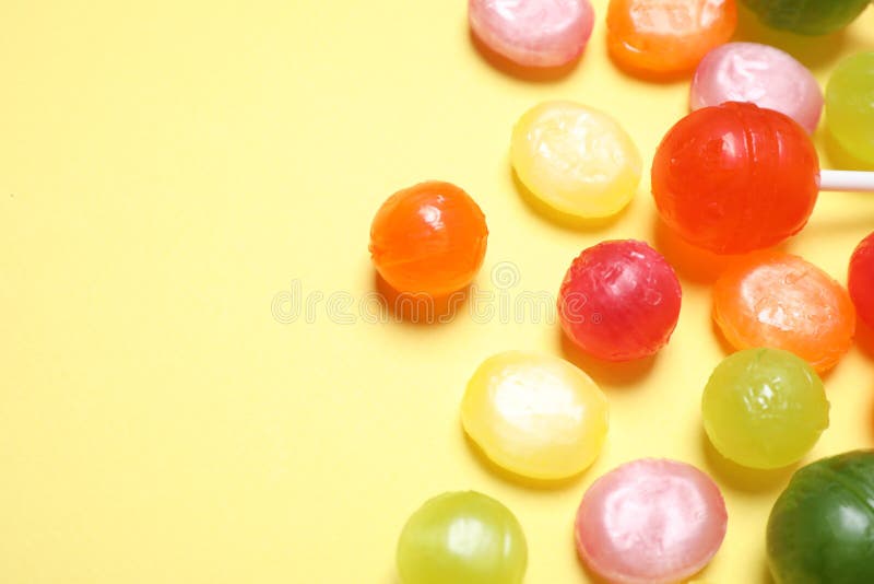 Many Different Hard Candies on Yellow Background, Closeup. Space for ...