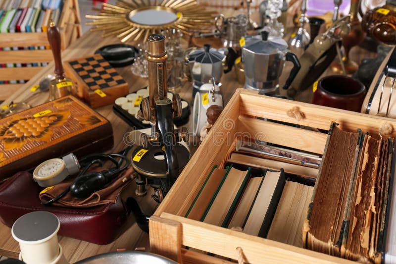 Many Different Items on Wooden Table. Garage Sale Stock Photo - Image ...