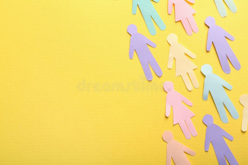 Many Different Paper Human Figures on Yellow Background, Flat Lay with ...
