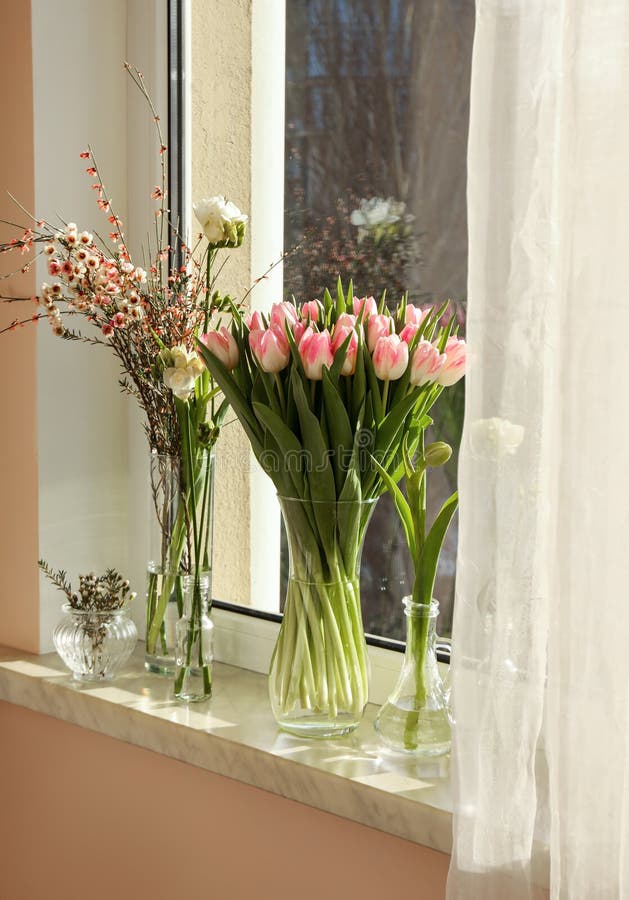 Many Different Spring Flowers and Branches with Leaves on Windowsill ...