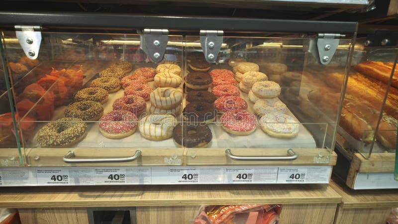 Many Donuts on Shelves in a Supermarket or Bakery. Stock Video - Video ...