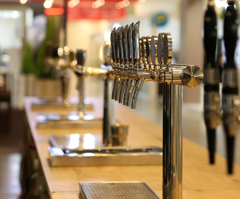 Beer Taps on the Counter of a Pub Stock Image - Image of barmaid, beer ...
