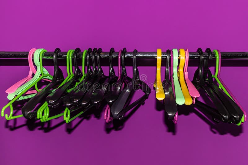 Many Empty Multi-colored Plastic Hangers Hanging on a Metal Rack Stock ...