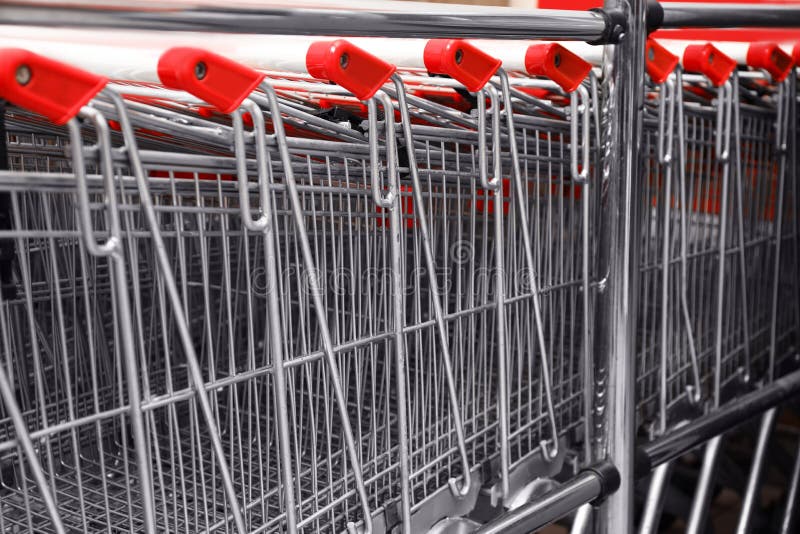 Many Empty Shopping Carts in Supermarket Stock Photo - Image of ...