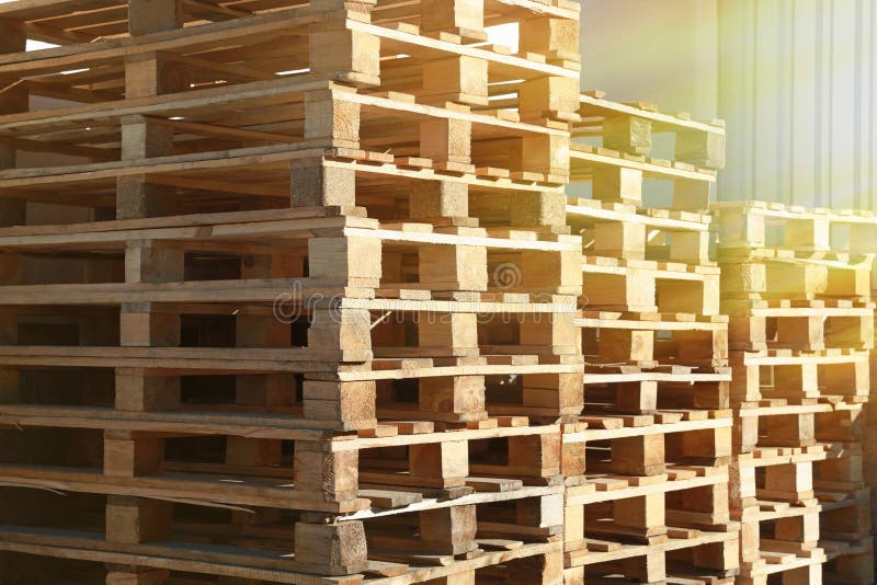 Many Empty Wooden Pallets Stacked in Warehouse Stock Image - Image of ...