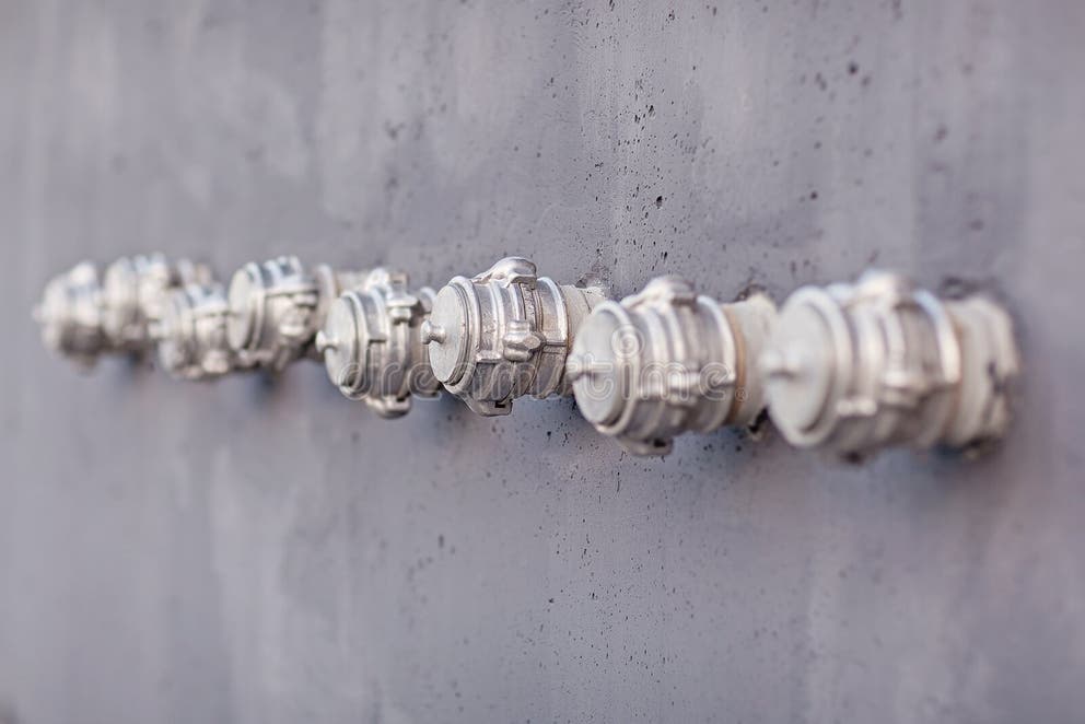 Many Fire Hydrants on Grey Wall Stock Photo - Image of steel, services ...