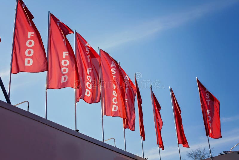 Many Flags with Fast Food Sign, Blown from the Wind Stock Image - Image ...