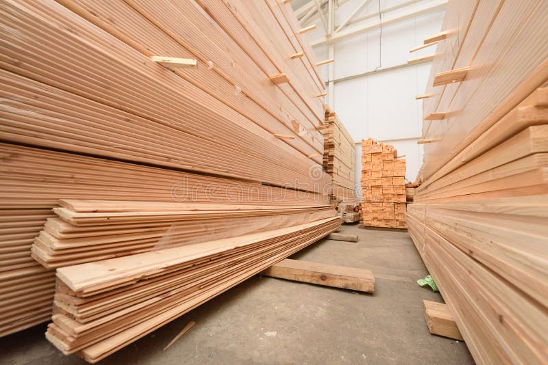 Many Folded Wooden Planks in a Warehouse with a Forest Stock Photo ...
