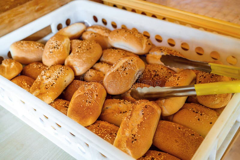 Many Fresh Baked Bun in Plastic Box with Pliers in Bakery Stock Photo ...