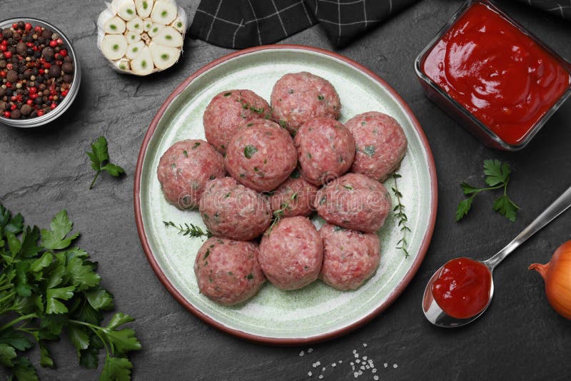 Many Fresh Raw Meatballs and Ingredients on Black Table, Flat Lay Stock ...