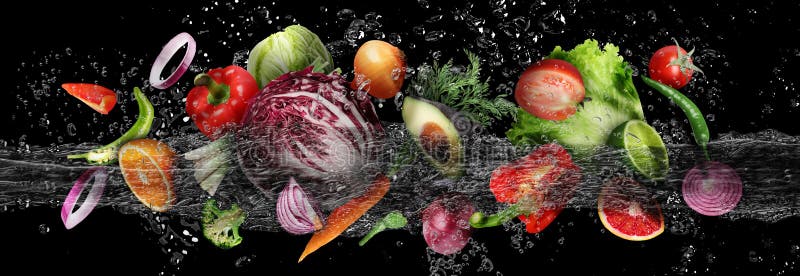 Many Fruits and Vegetables Falling into Water Against Black Background ...