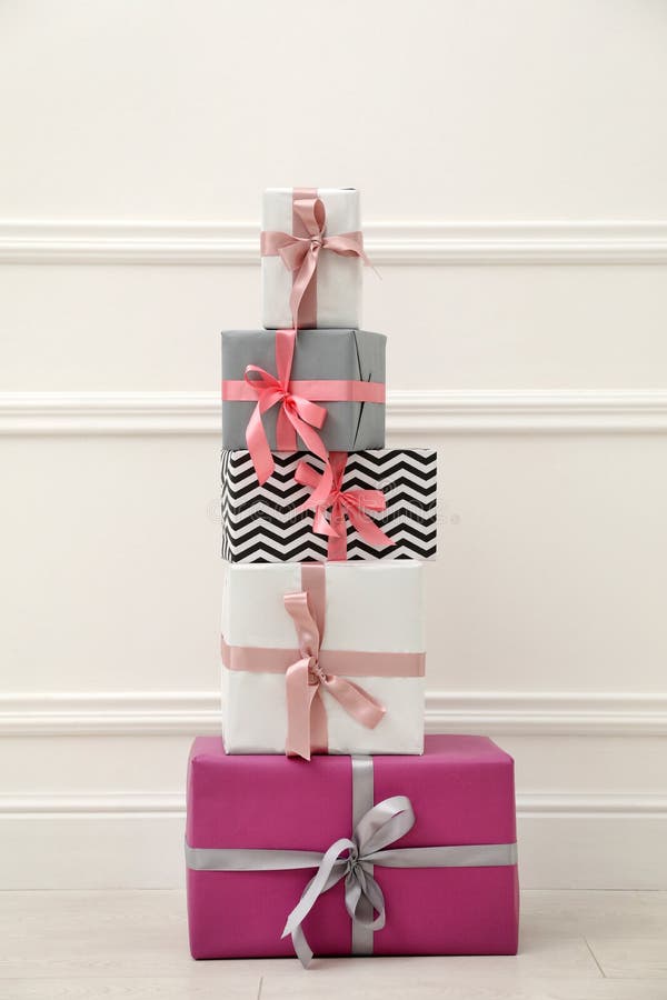Many Gift Boxes with Colorful Bows Near White Wall Stock Image - Image ...