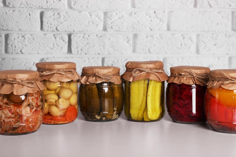 Many Glass Jars with Different Preserved Vegetables and Mushrooms on ...