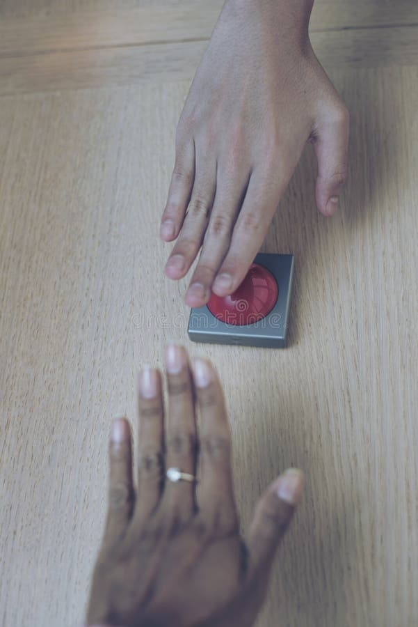 Many Hand Grab for the Red Button on Wood Table. Stock Image - Image of ...