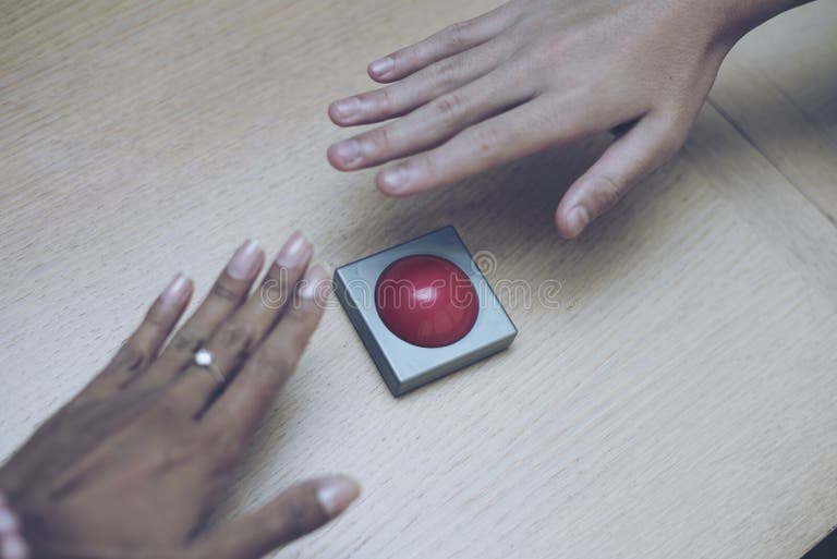 Many Hand Grab for the Red Button on Wood Table. Stock Photo - Image of ...