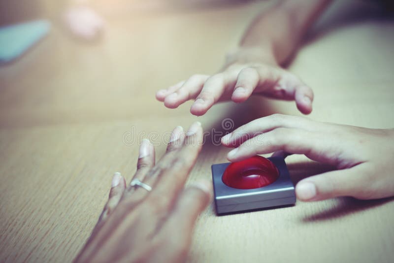 Many Hand Grab for the Red Button on Wood Table. Stock Image - Image of ...