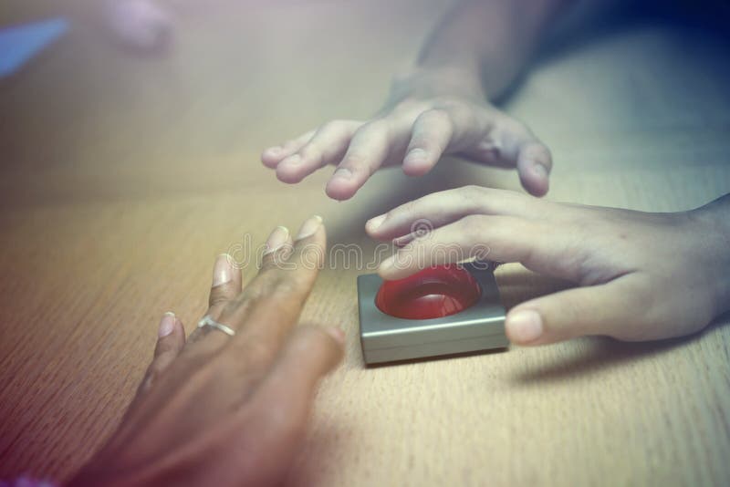Many Hand Grab for the Red Button on Wood Table. Stock Photo - Image of ...