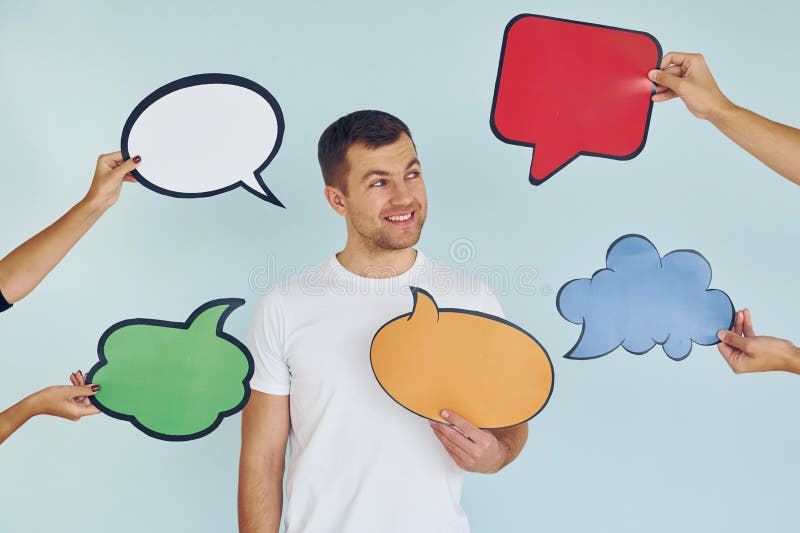 Many Hands Holding Signs. Man Standing in the Studio Stock Photo ...