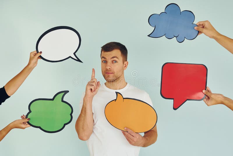 Many Hands Holding Signs. Man Standing in the Studio Stock Photo ...