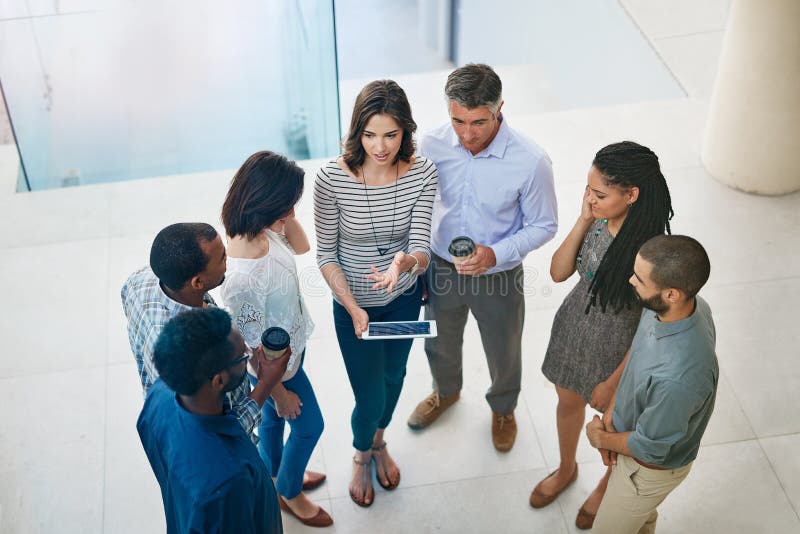 Many Hands Make Light Work. High Angle Shot of Businesspeople Talking ...