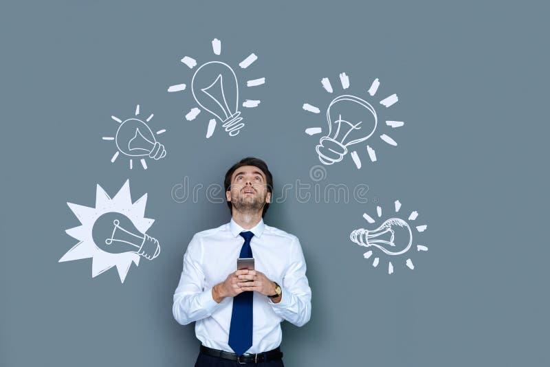 Creative Programmer Holding a Smartphone and Getting New Ideas Stock ...