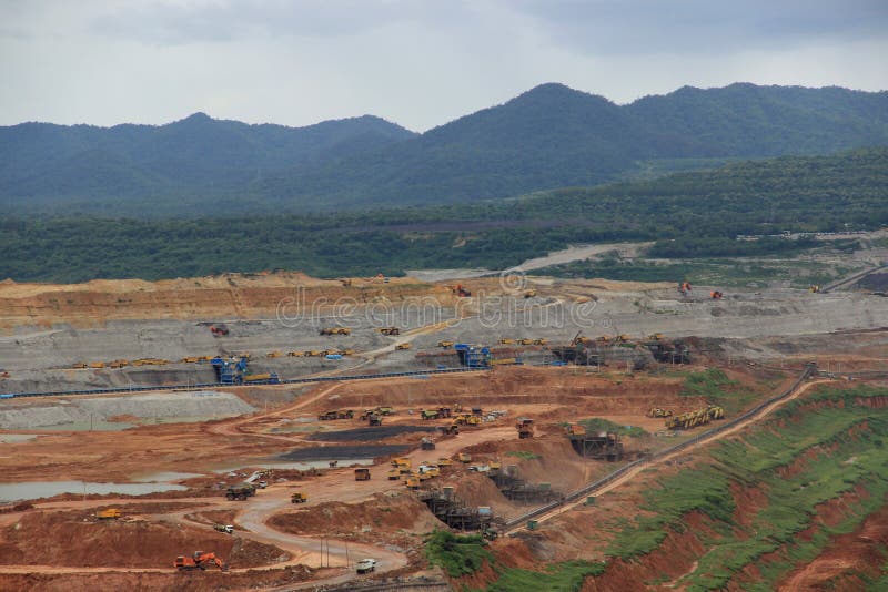 Machines are Working in Large Mines with Mountains As Background Stock ...