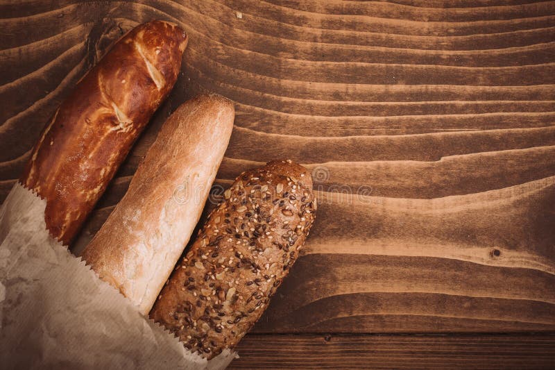 Many Mixed Baked Breads and Rolls on Rustic Wooden Table Stock Photo ...