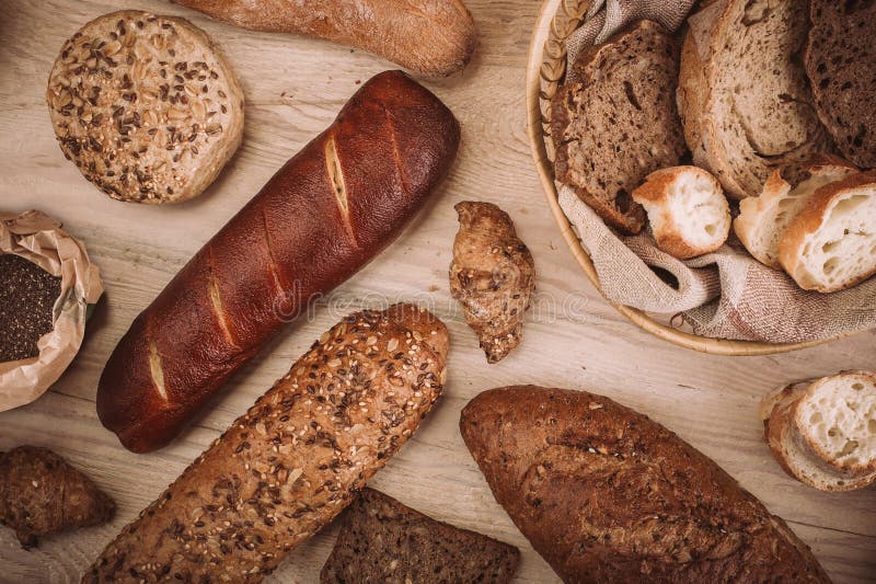 Many Mixed Baked Breads and Rolls on Rustic Wooden Table Stock Image ...
