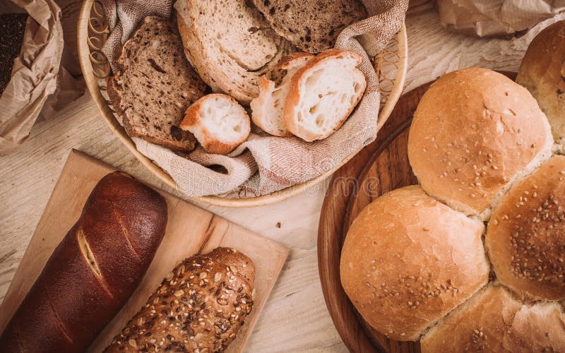 Many Mixed Baked Breads and Rolls on Rustic Wooden Table Stock Image ...