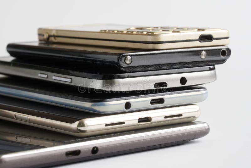 Many Mobile Phones of Different Generations and an Electronic Tablet on ...
