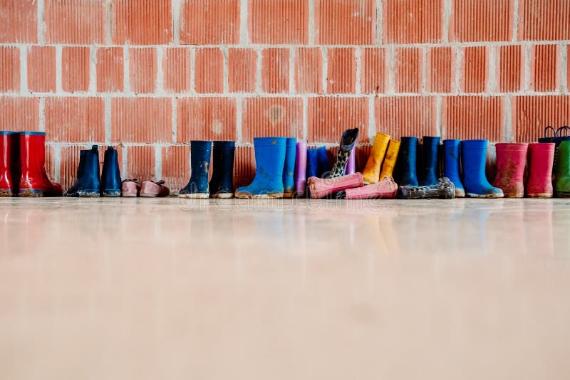Many Muddy Colored Wellies on the Ground Stock Photo - Image of space ...