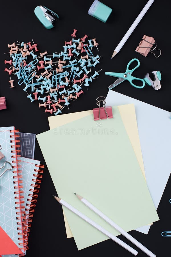 Many Multi-colored Paper Clips And Paper On A Black Background. Office ... Many Multi-colored Paper Clips And Paper On A Black Background. Office ...