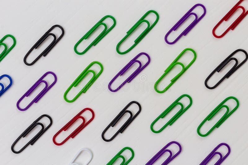 Many Multi-colored Paper Clips Lie on a White Wooden Table Stock Photo ...