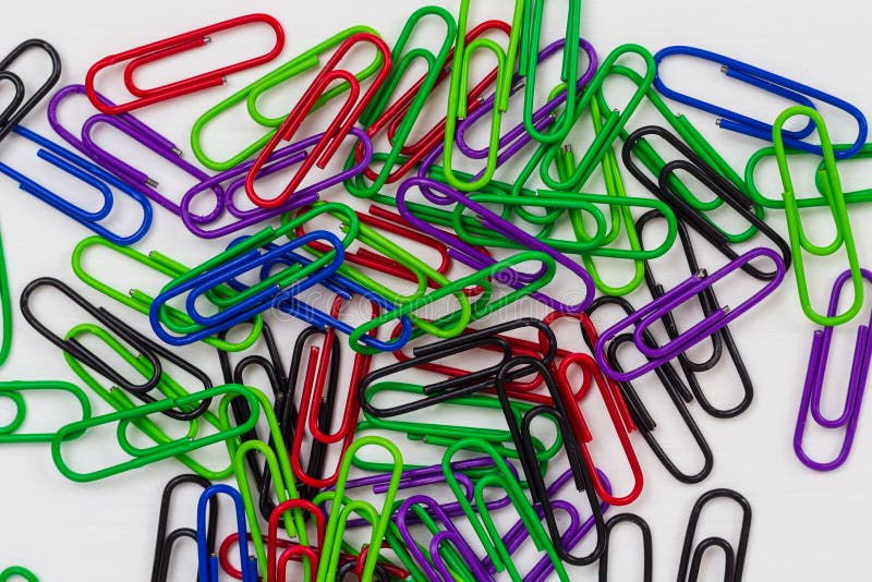 Many Multi-colored Paper Clips Lie on a White Wooden Table Stock Photo ...