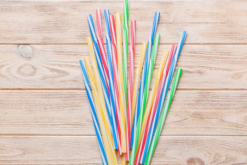 Many Multi-colored Plastic Tubes for Cocktail on Colored Background ...