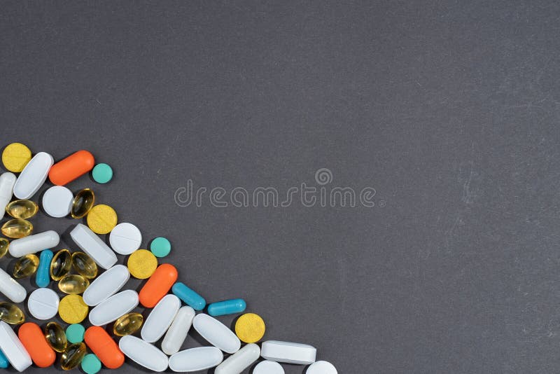 Many Multi-colored Tablets of Different Shapes in the Corner Against a ...