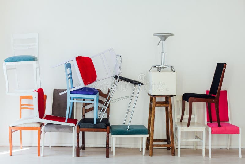 Many Multicolored Chairs in the Mess of the White Room Stock Photo ...