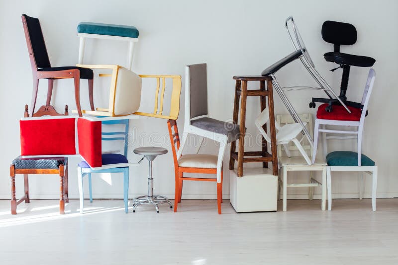 Many Multicolored Chairs in the Mess of the White Room Stock Photo ...