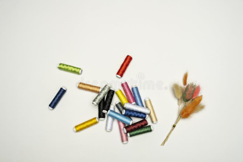 Many New Spools of Thread in All Colors Along with a Small Bouquet of ...