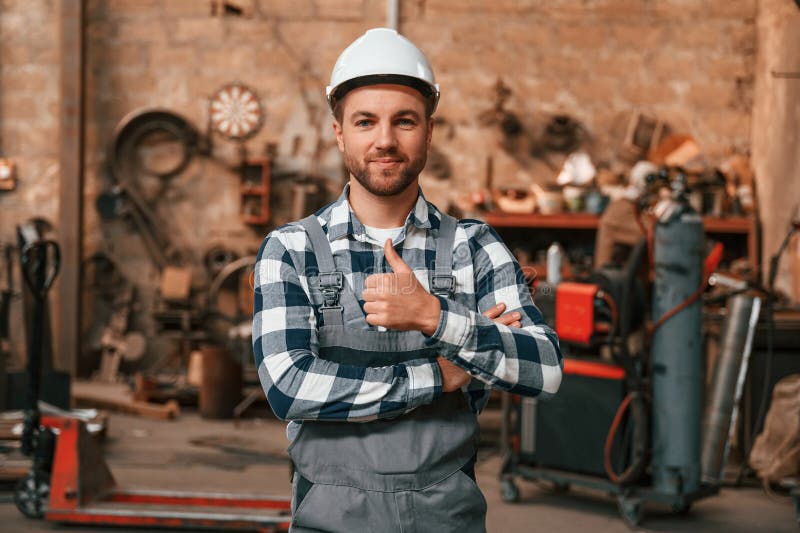 Many Objects Behind. Factory Male Worker in Uniform is Indoors Stock ...
