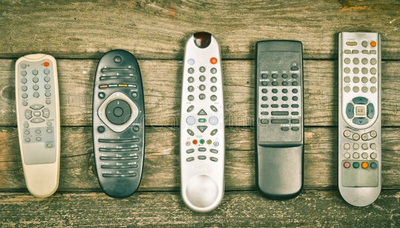 Many Old TV Remotes on a Wooden Background. Top View Stock Photo ...