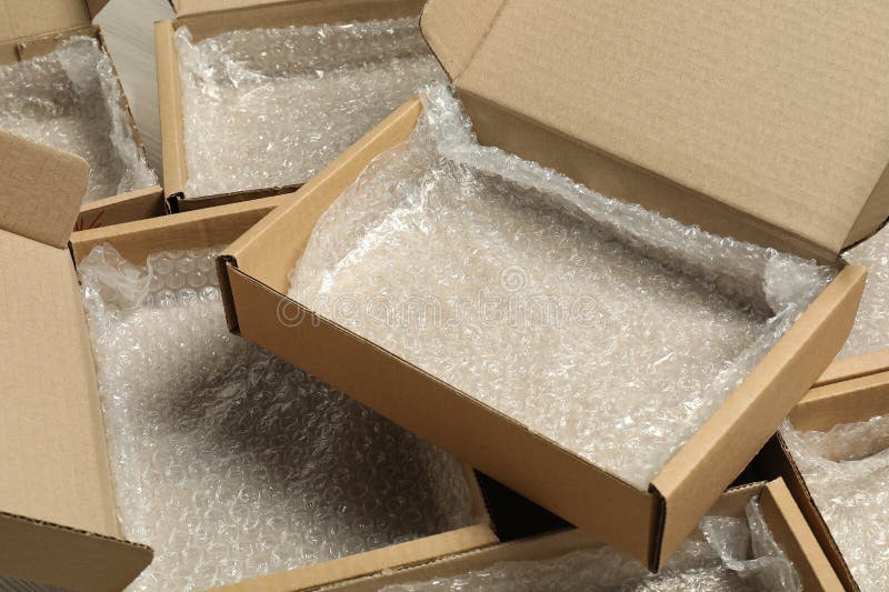 Many Open Cardboard Boxes with Bubble Wrap on Floor, Closeup. Packaging ...