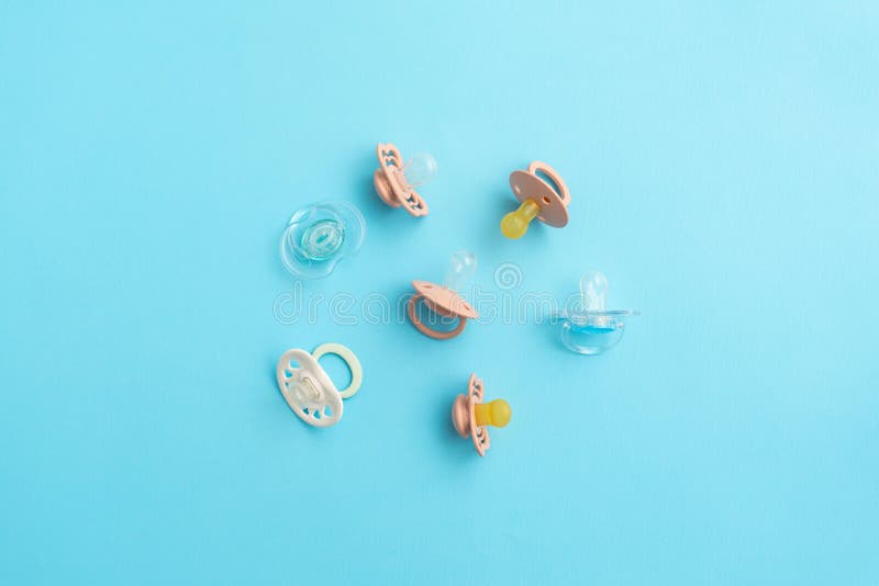 A Lot of Pacifiers on Blue Background with Copy Space, Top View of ...