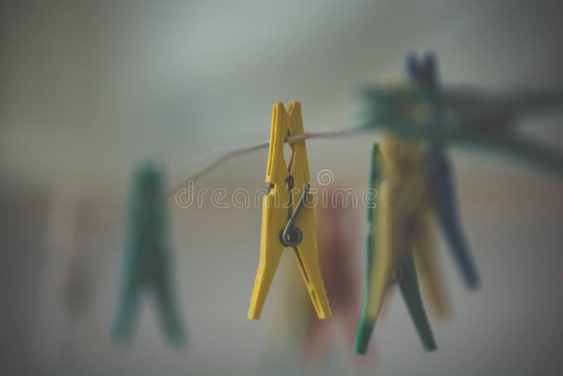 Many Pegs for Laundry Bundled Together with the Yellow Peg on Focus ...