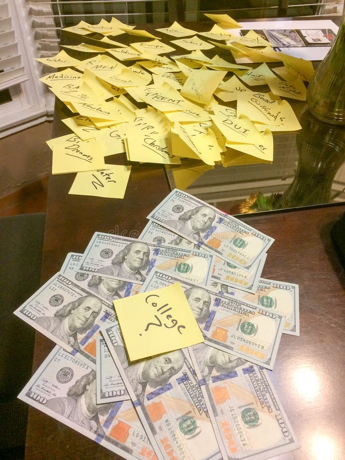 Many Post it Notes on Table with Pile of American Hundred Dollar Bills ...