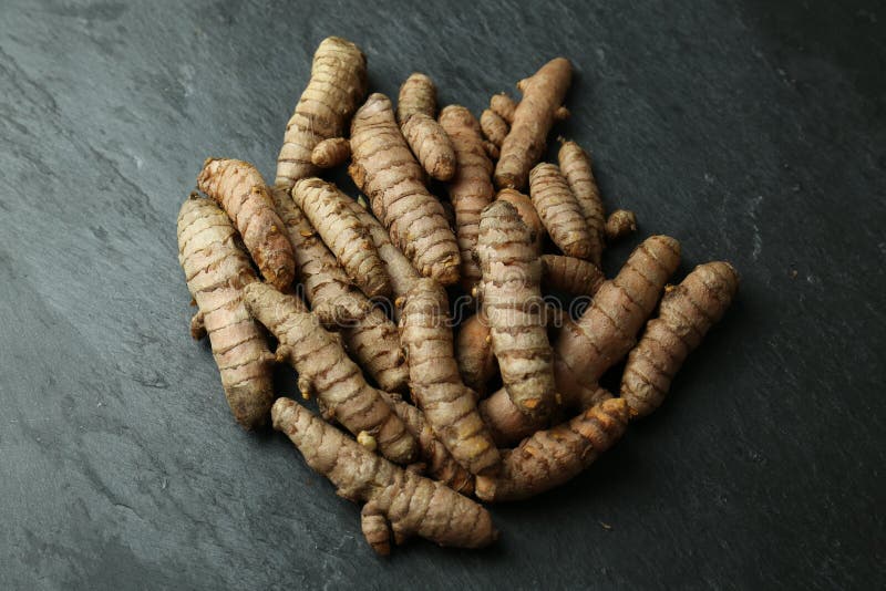 Many Raw Turmeric Roots on Black Textured Table, Above View Stock Photo ...