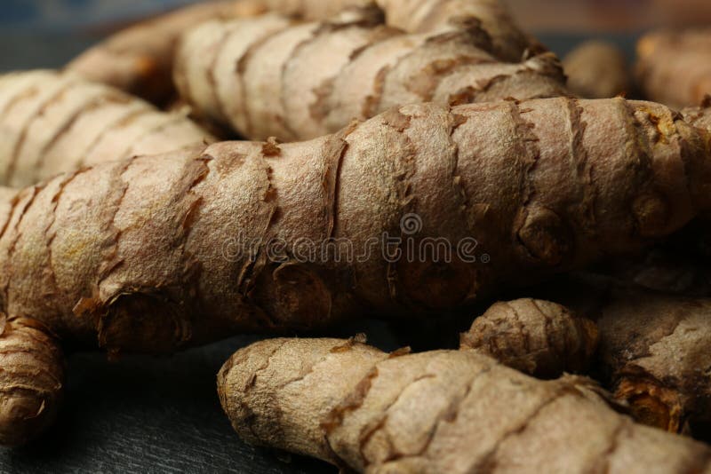 Many Raw Turmeric Roots on Black Textured Table, Closeup Stock Image ...