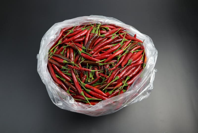 Many Red Peppers in a Plastic Bag on a Black Back Stock Photo - Image ...