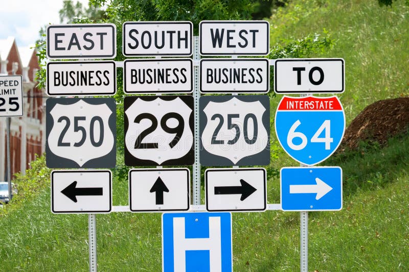 Many Road Signs at the Intersection Pointing in Ifferent Directions at ...