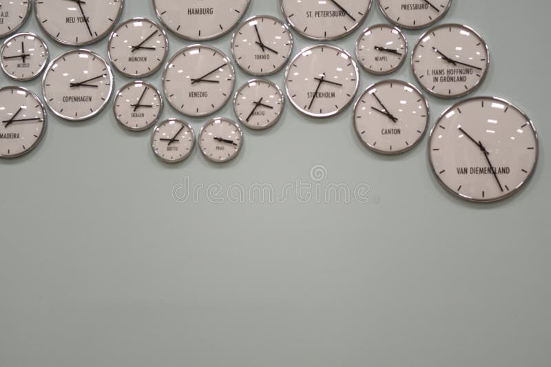 Many Round Analogue Clocks on White Wall Stock Photo - Image of analog ...
